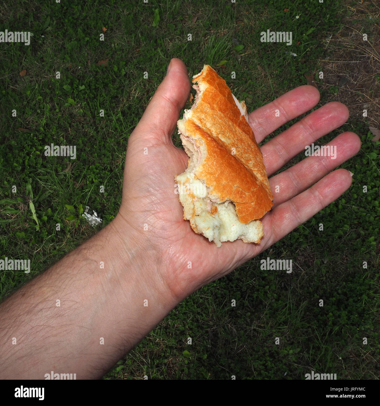 Man holding ham baguette Stock Photo - Alamy