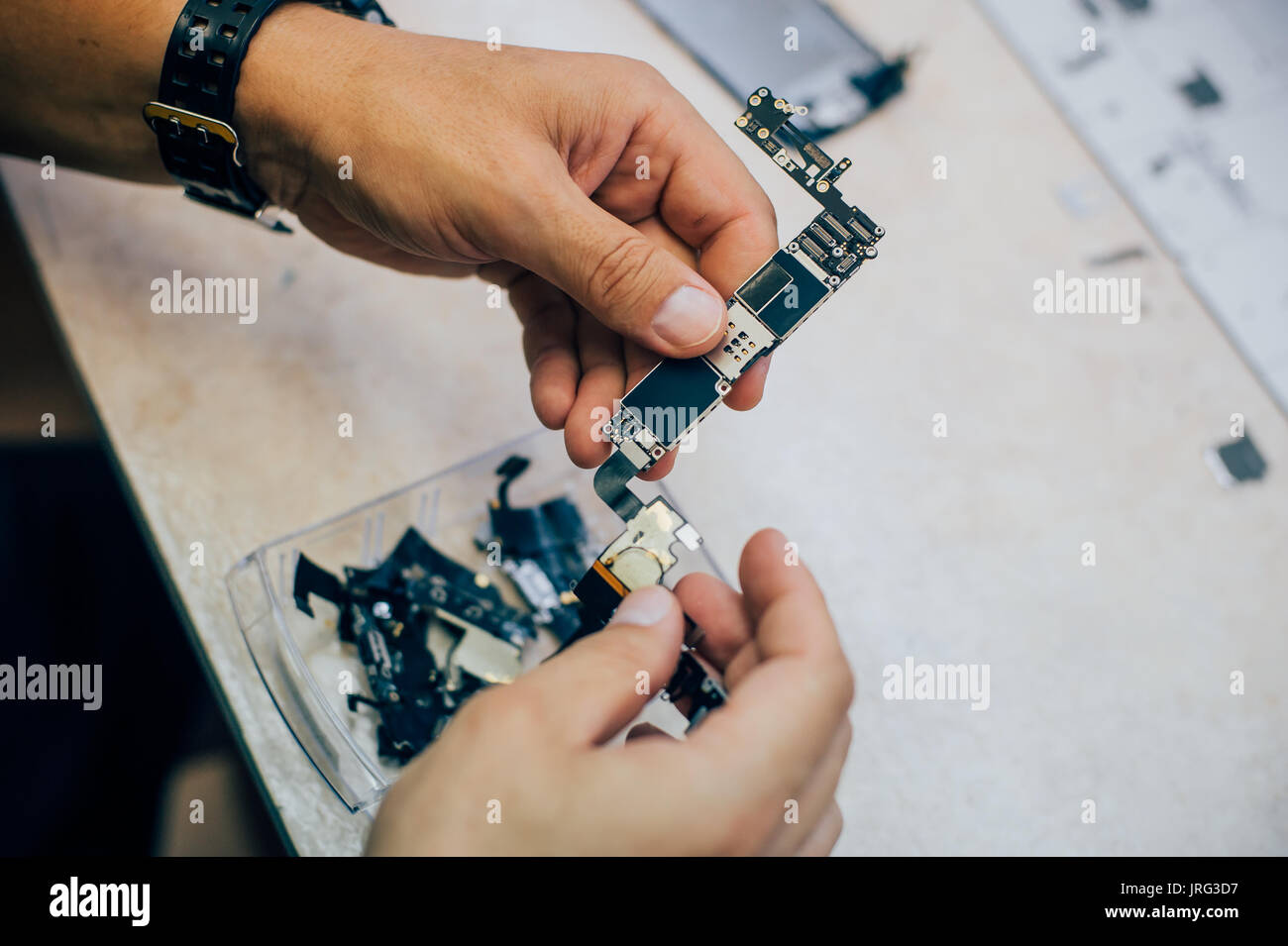 Technician repair microchip and motherboard of mobile phone in ...