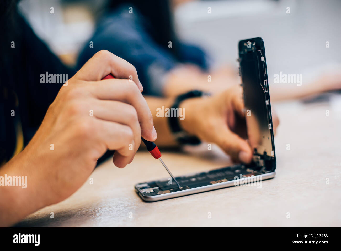 Technician repair faulty mobile phone in electronic smartphone ...