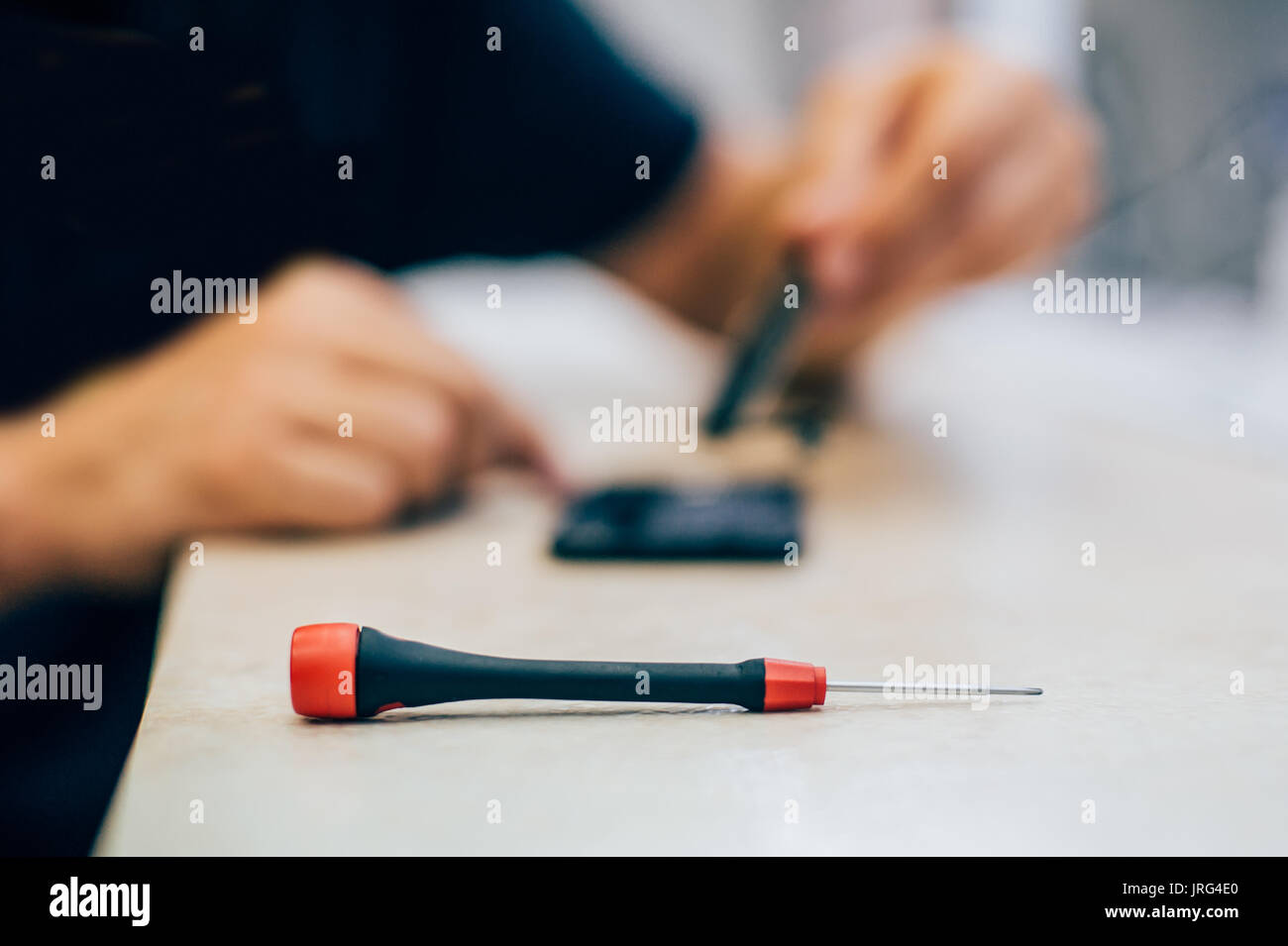 Technician repair faulty mobile phone in electronic smartphone ...