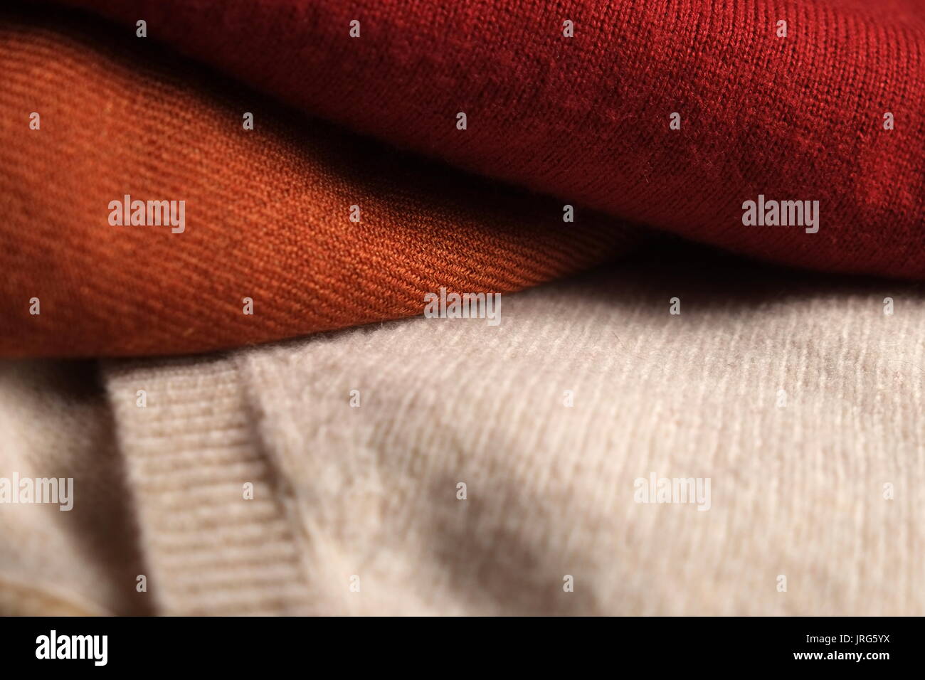 Stack of folded sweaters. Autumn and Winter collection Stock Photo - Alamy