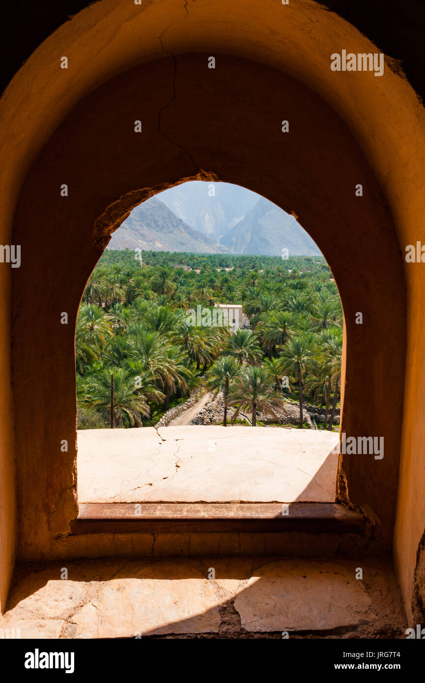 View of date plantation through arched window -Nakhal Fort Oman Stock ...