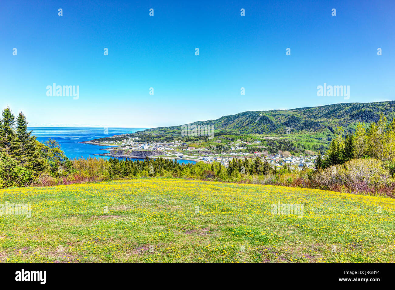 Cityscape of Grande-Vallee village town and Saint-Lawrence river during ...