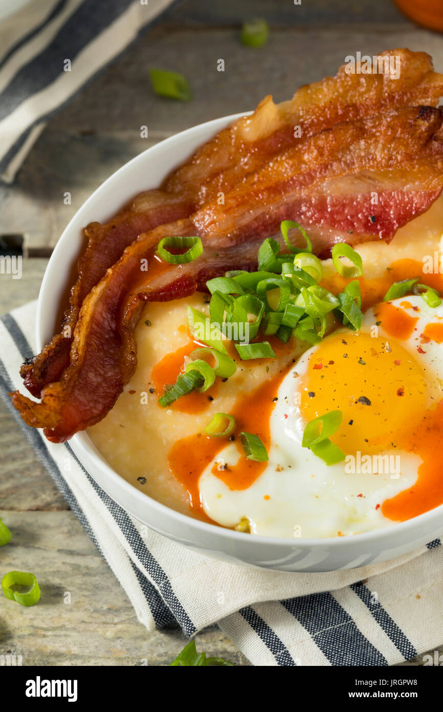 Homemade Cheesy Breakfast Grits with Eggs and Bacon Stock Photo - Alamy