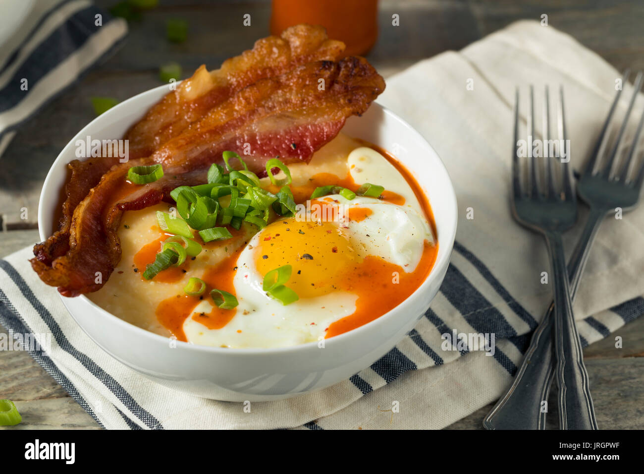 Homemade Cheesy Breakfast Grits with Eggs and Bacon Stock Photo - Alamy
