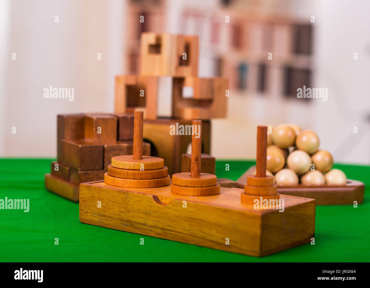 Assorted wooden brain teaser or wooden puzzles on green table in a ...