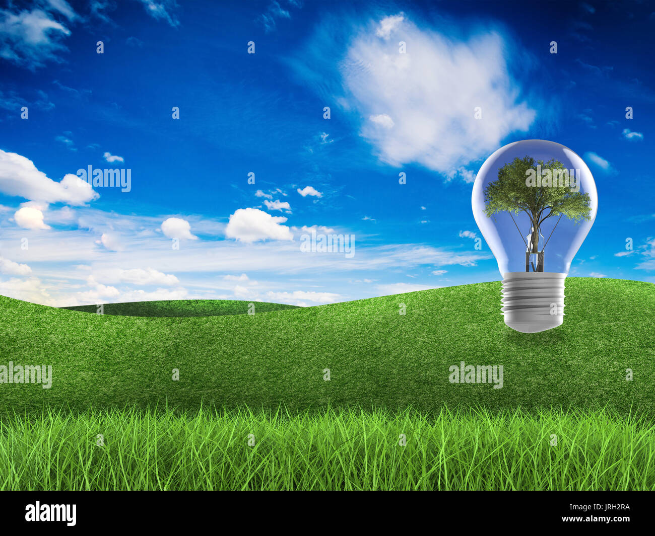 think green concept with light bulb in green field and blue sky ...