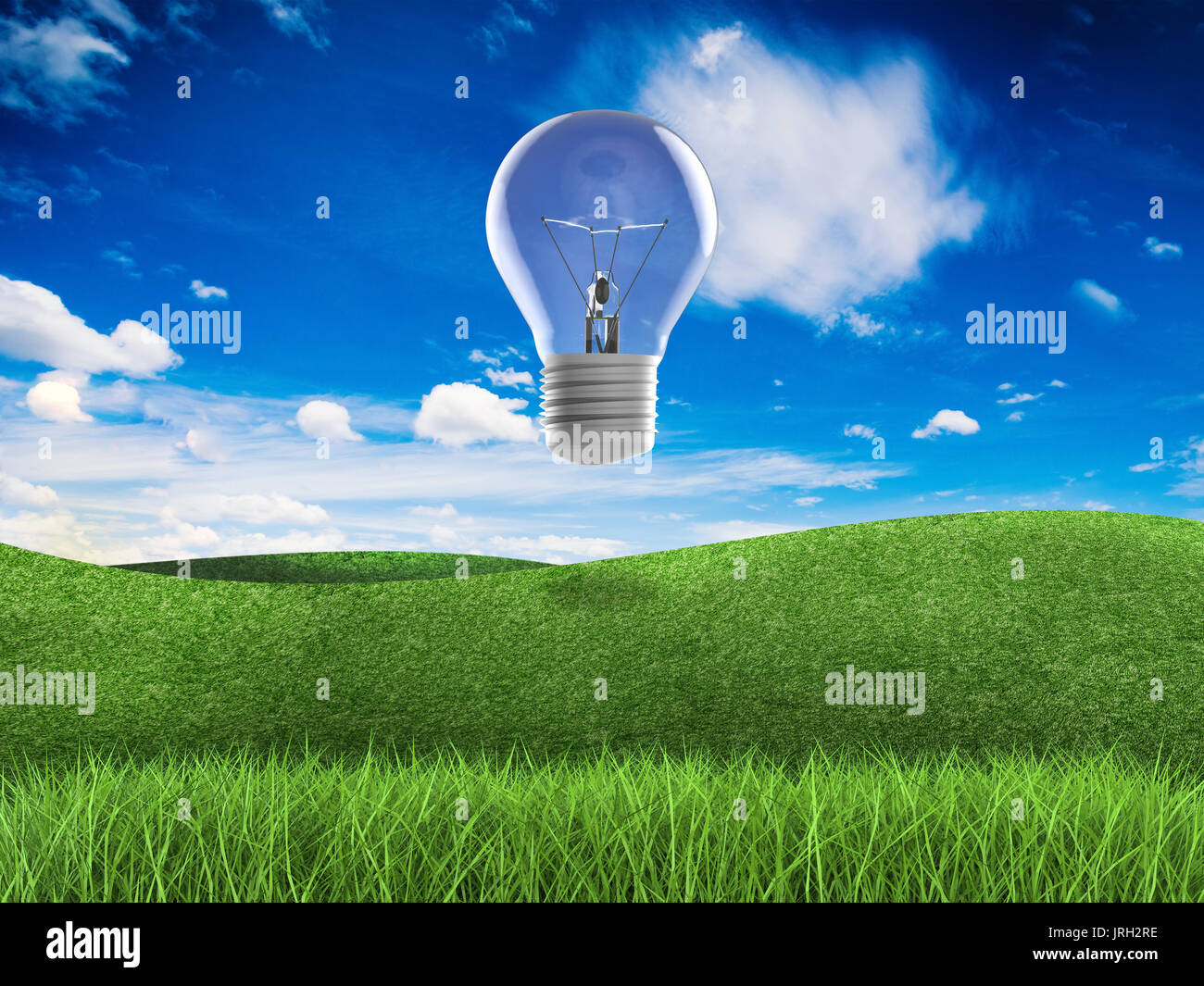 think green concept with light bulb in green field and blue sky ...