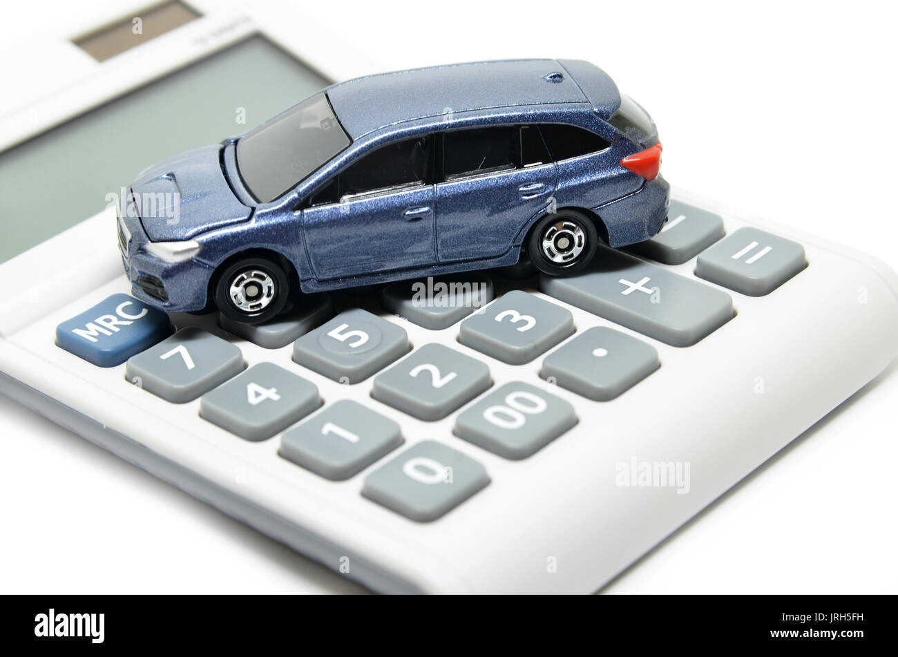 Calculator and toy car isolated on white background Stock Photo - Alamy