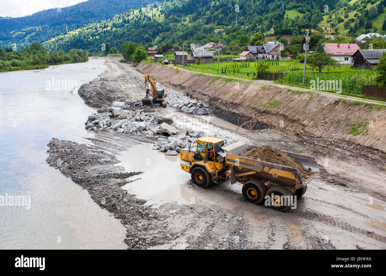 truck and excavator on a construction site in river Stock Photo - Alamy