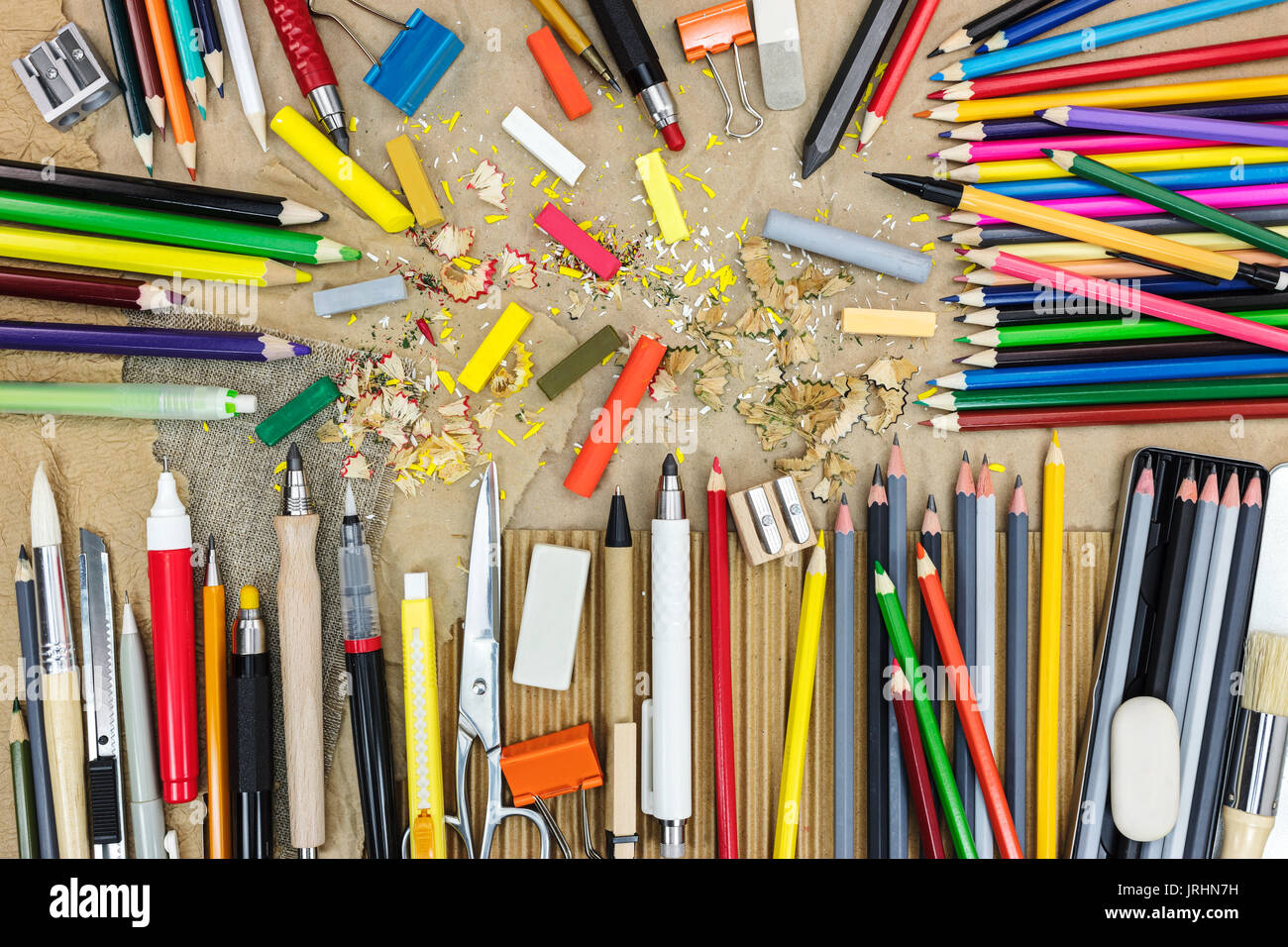 artist work tools on brown recycled paper top view. multicolored ...
