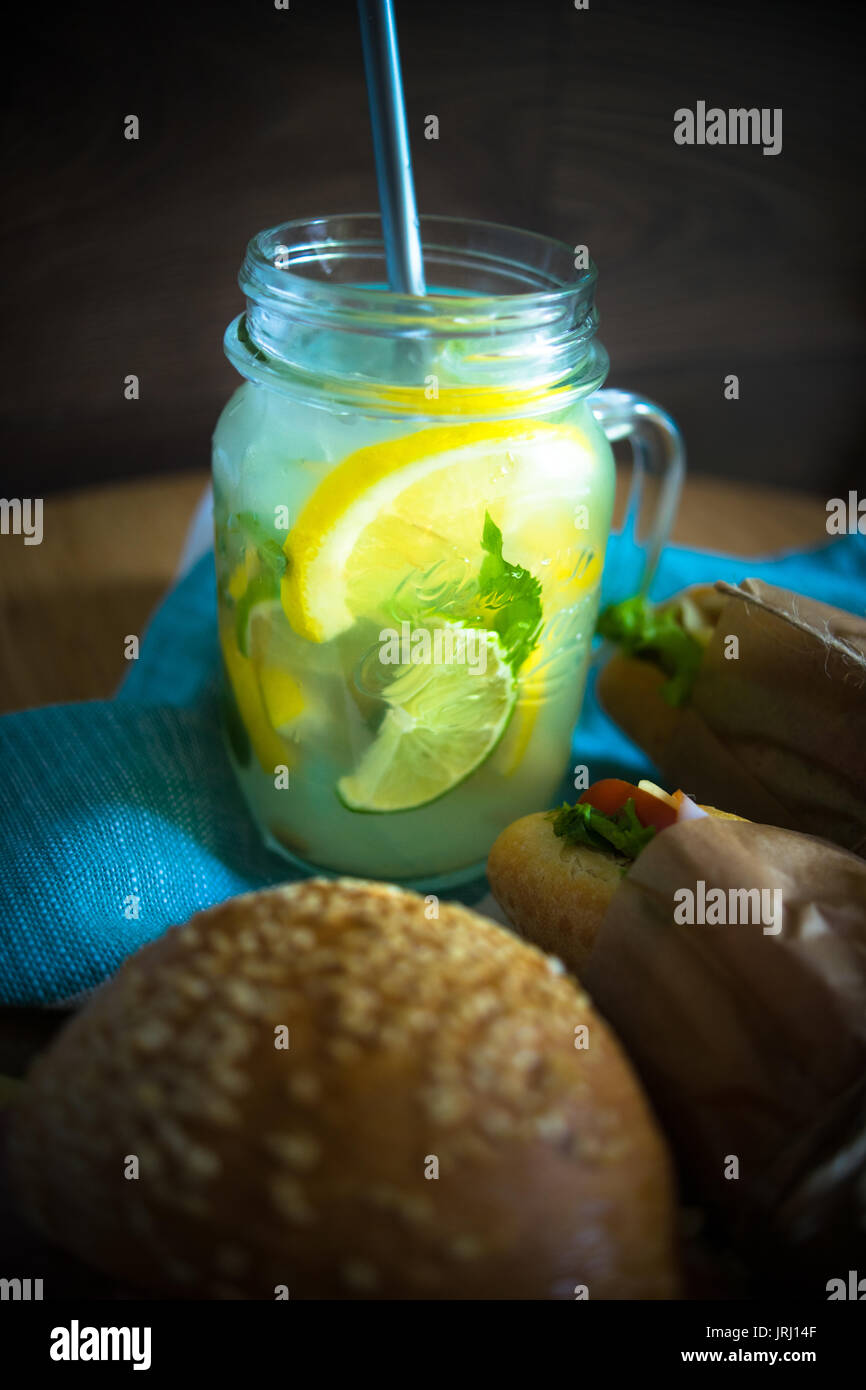 Snack concept with lemonade and cheeseburgers on dark background Stock ...