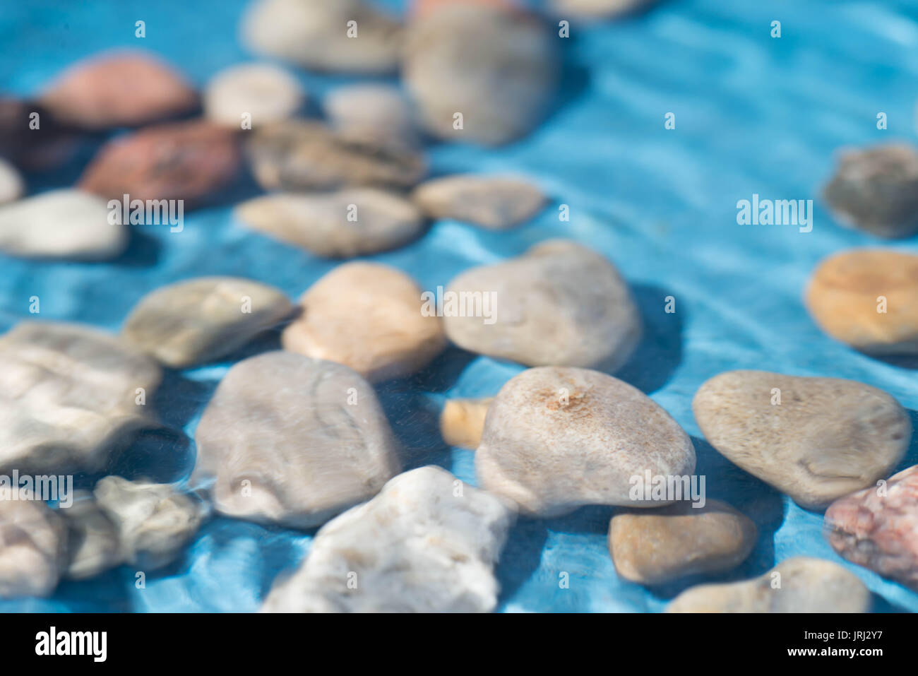 pebble stones in water closeup Stock Photo - Alamy