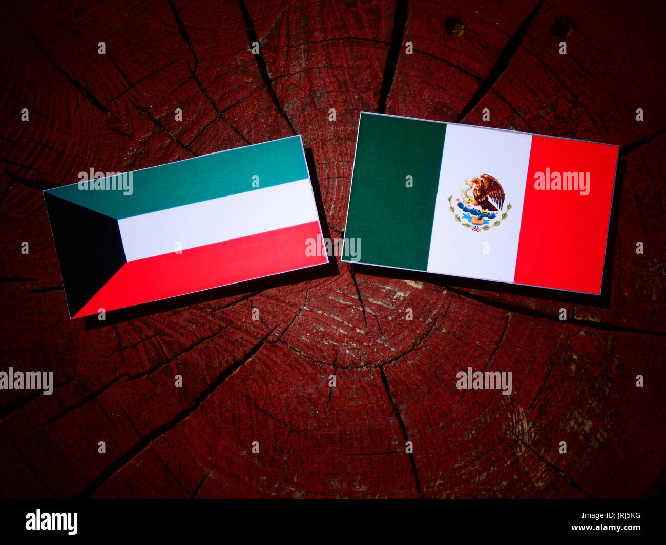 Kuwaiti flag with Mexican flag on a tree stump isolated Stock Photo - Alamy