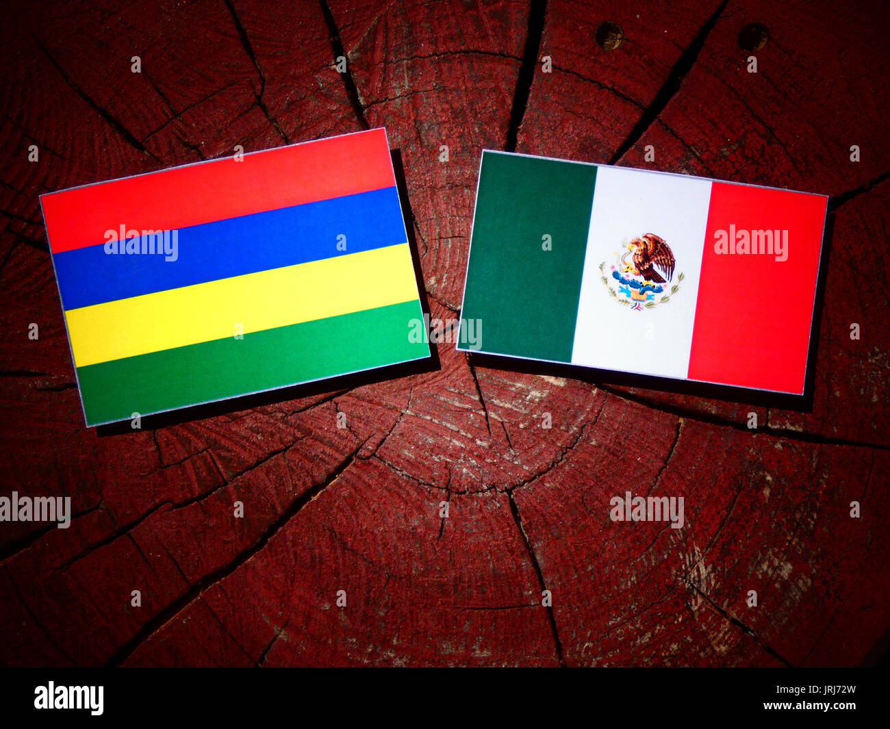 Mauritius flag with Mexican flag on a tree stump isolated Stock Photo ...