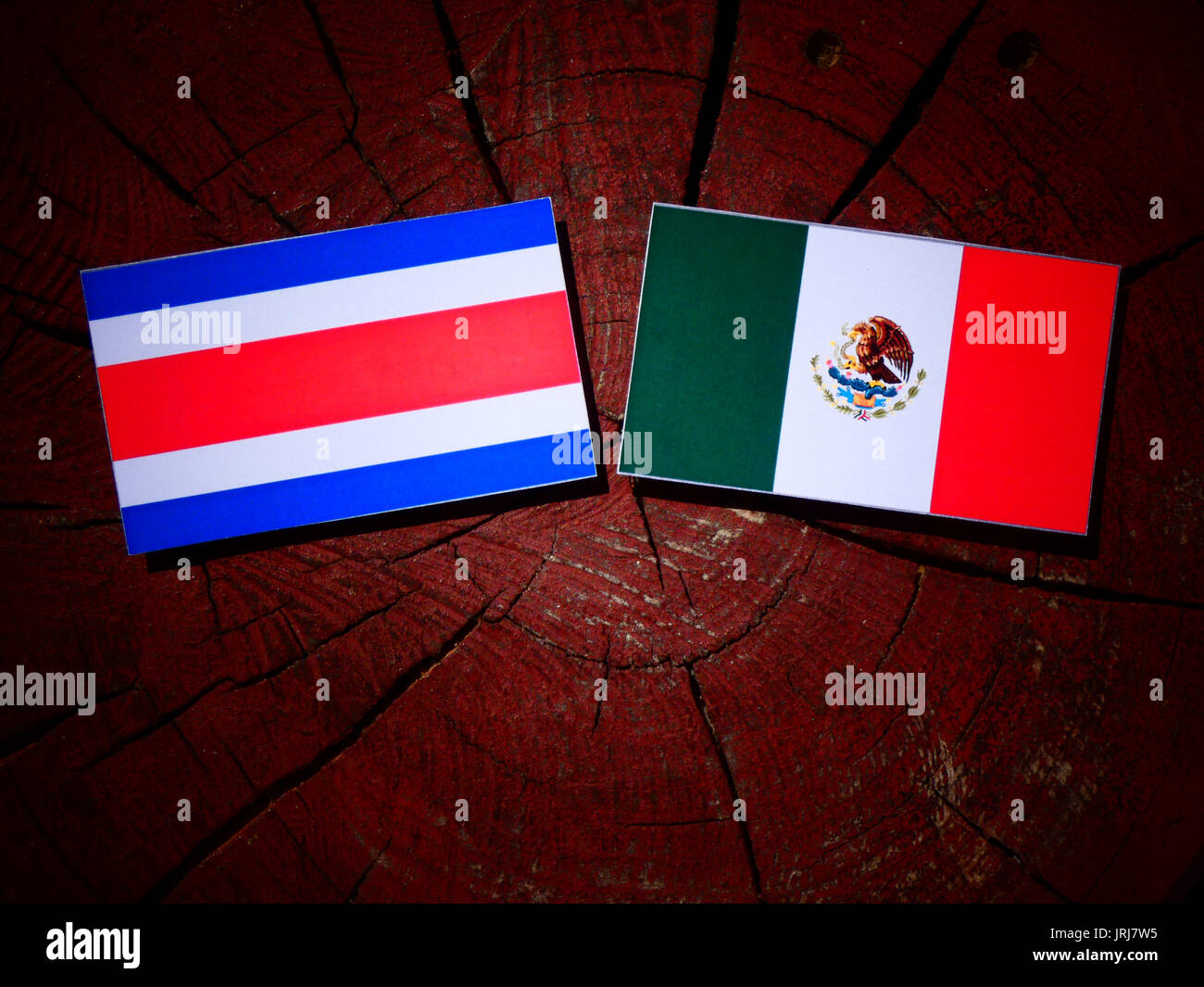 Costa Rican flag with Mexican flag on a tree stump isolated Stock Photo ...