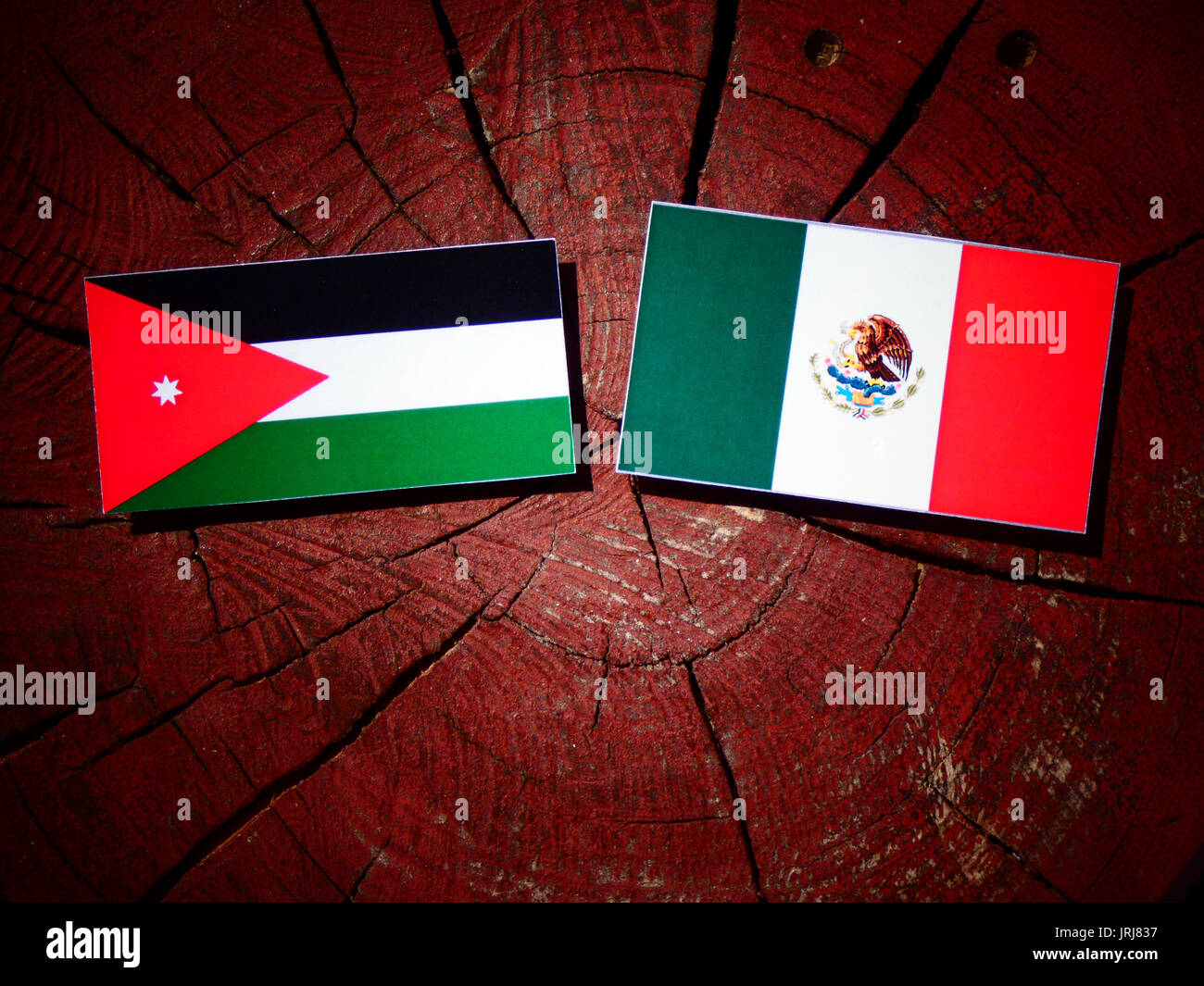 Jordanian flag with Mexican flag on a tree stump isolated Stock Photo ...