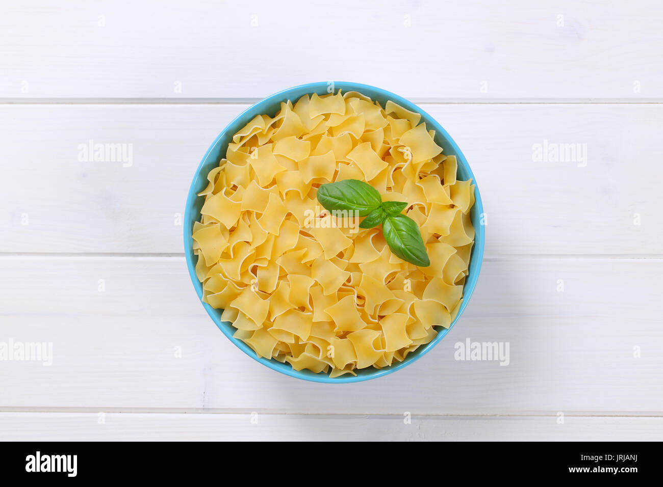 bowl of quadretti - square shaped pasta on white wooden background ...