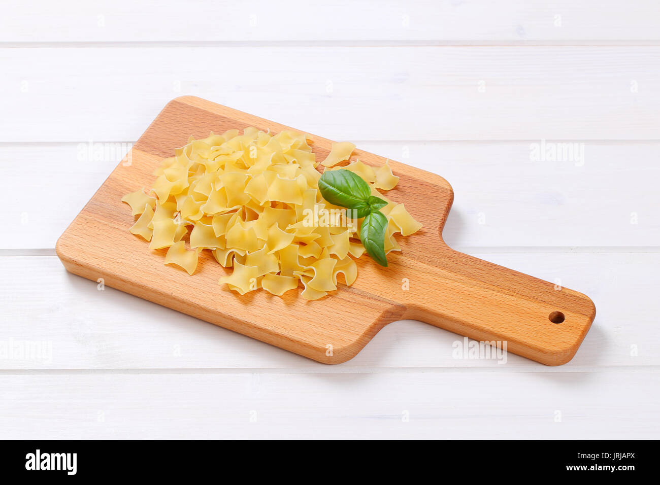 pile of quadretti - square shaped pasta on wooden cutting board Stock ...