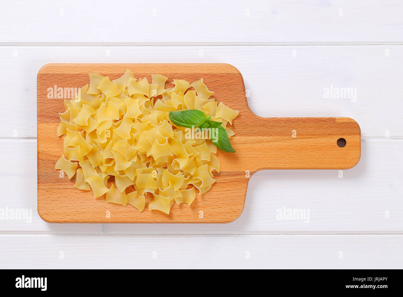 pile of quadretti - square shaped pasta on wooden cutting board Stock ...