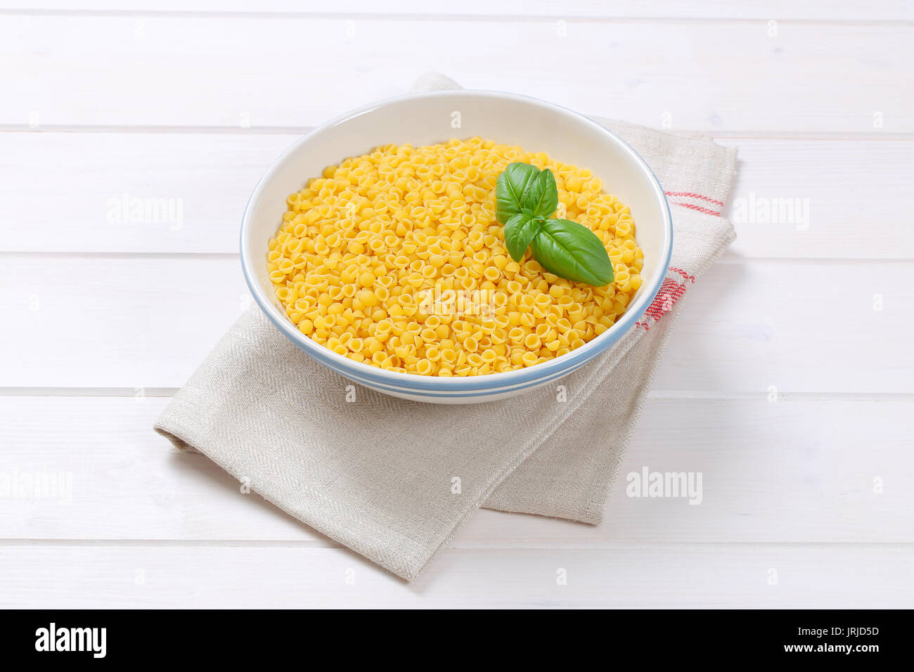 bowl of small pasta shells on folded place mat Stock Photo - Alamy