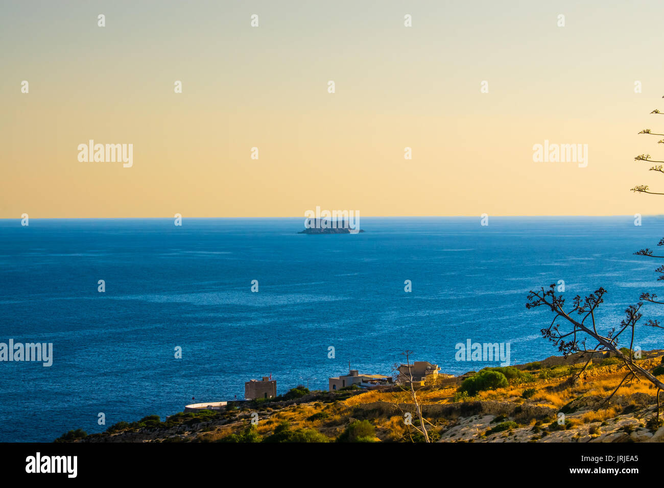 Filfla at Sunset. Filfla is a small, mostly barren, uninhabited islet ...