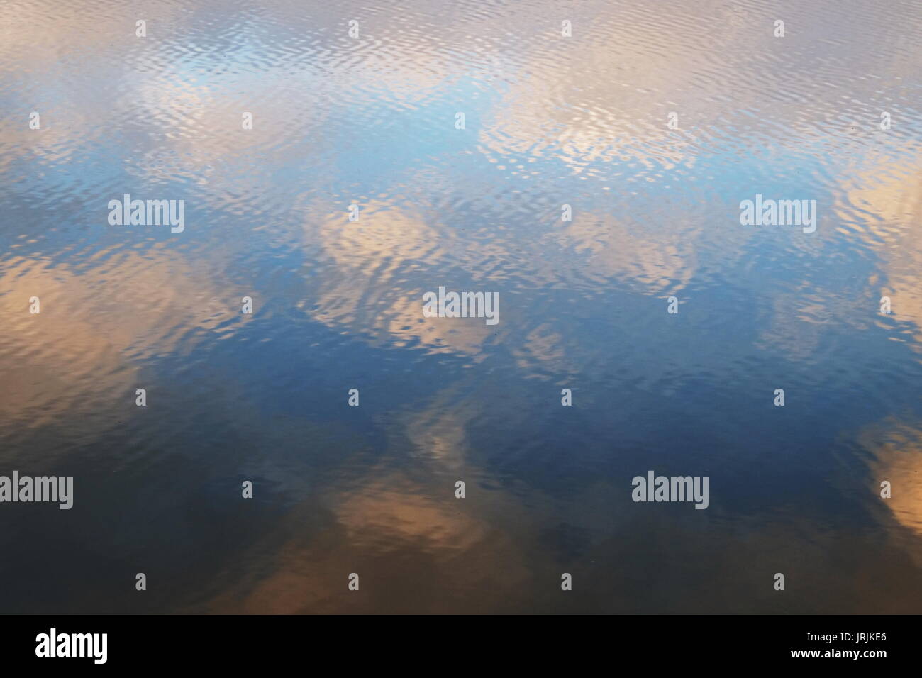 Sky reflected on lake surface Stock Photo - Alamy