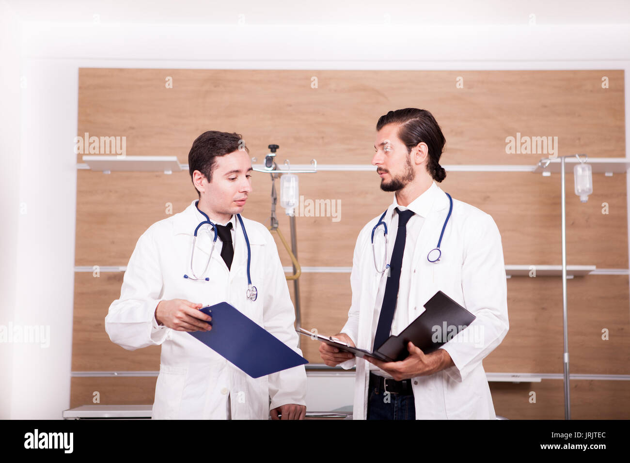 Confident team doctors talking patient hi-res stock photography and ...