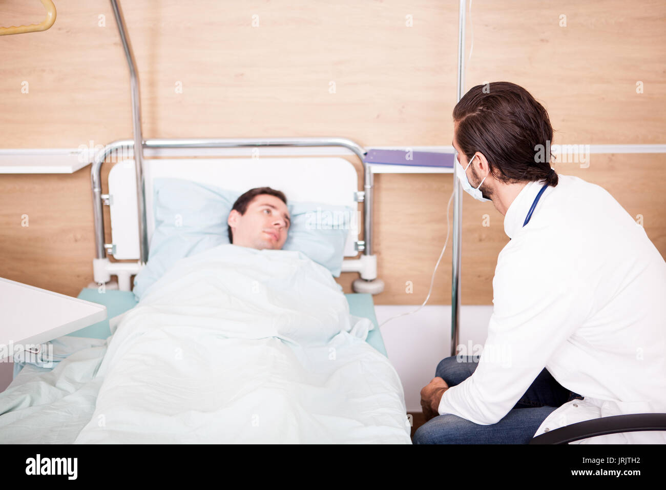 Doctor with patient in recovery room Stock Photo - Alamy