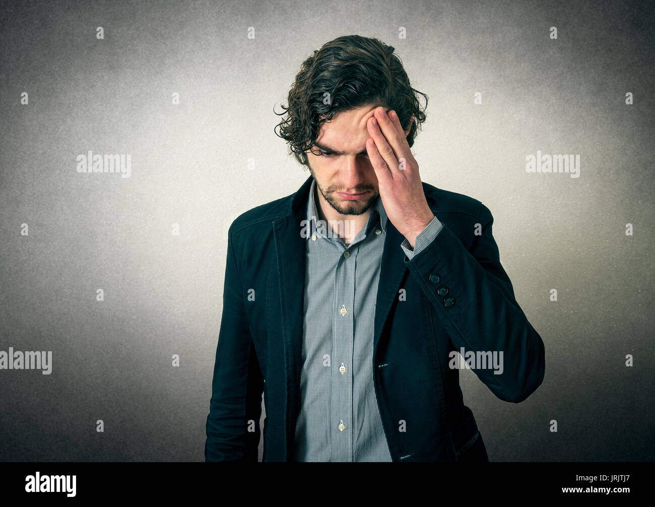 Bearded man thinking or has head pain Stock Photo - Alamy