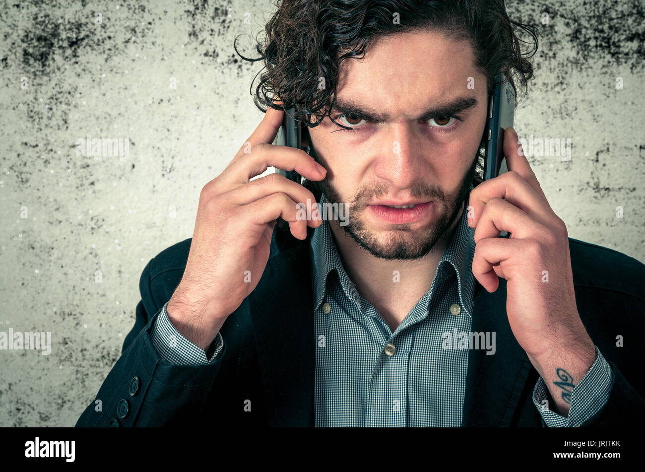 Angry man on the phones Stock Photo - Alamy