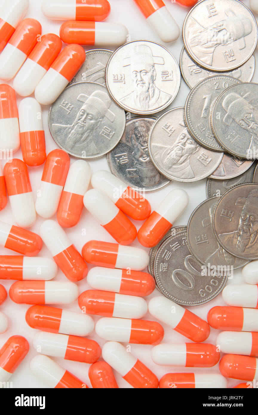 coins and pill on the white back ground Stock Photo - Alamy