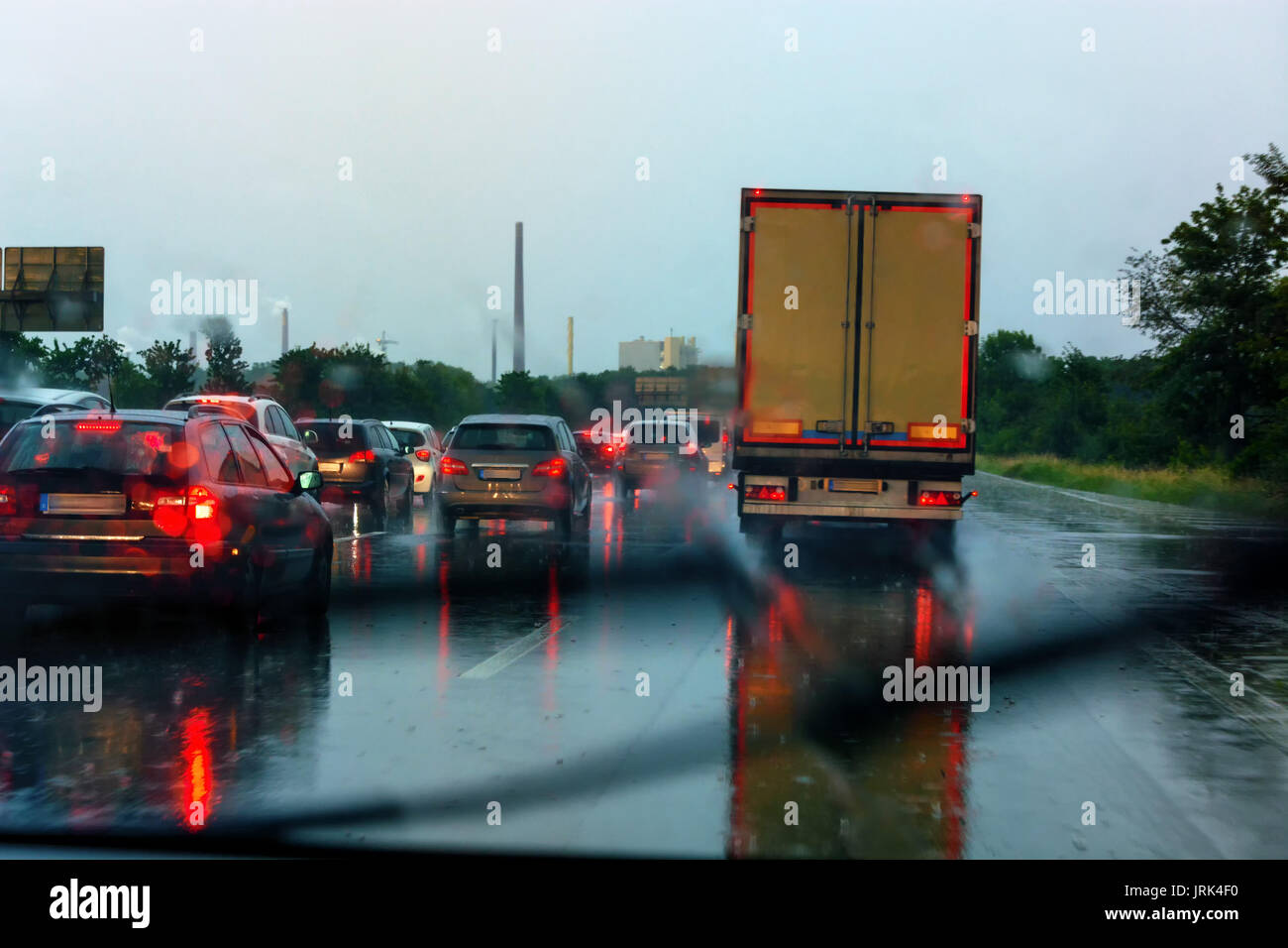 Danger of a traffic jam in heavy rain. Severe weather on the highway ...