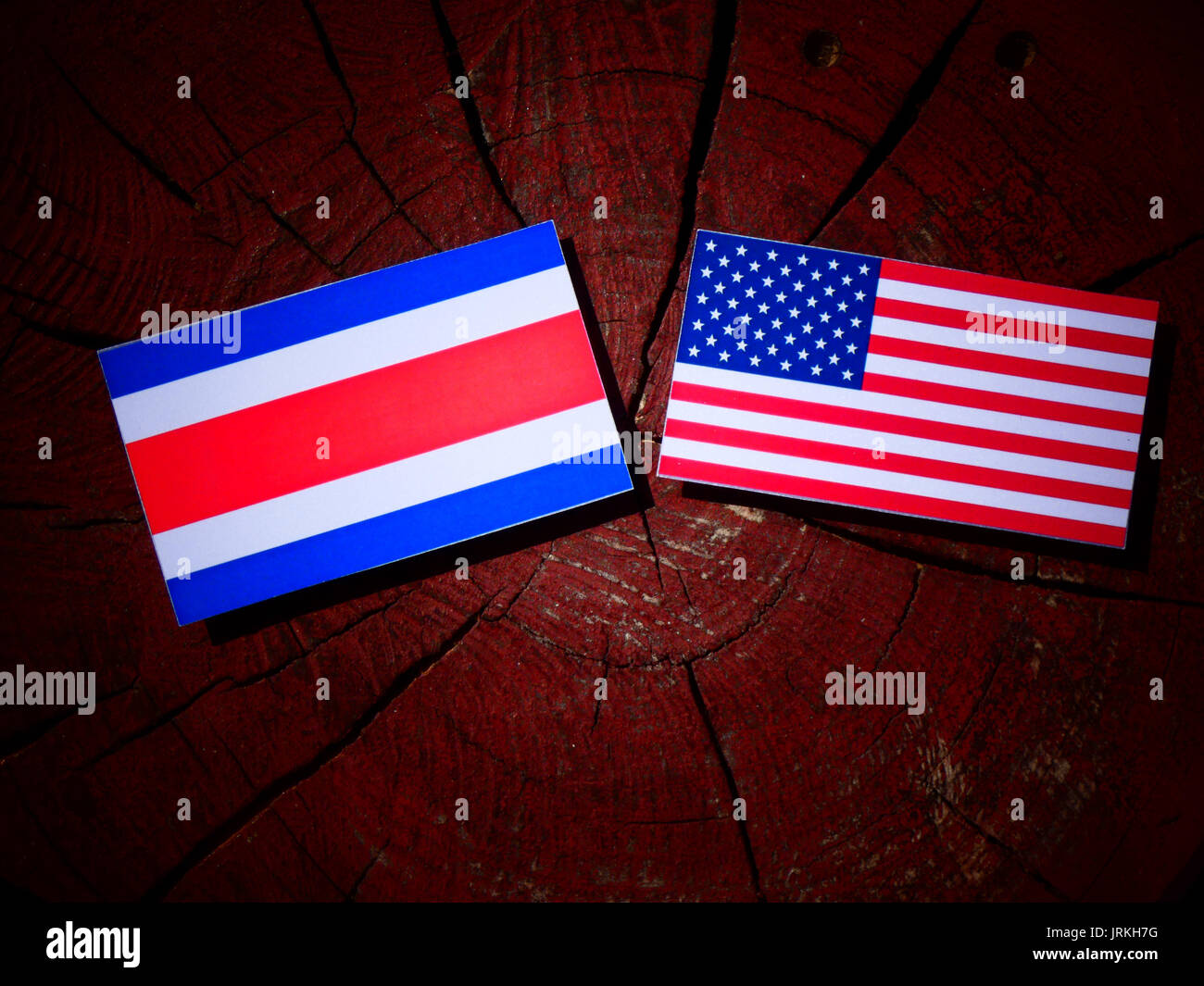 Costa Rican flag with USA flag on a tree stump isolated Stock Photo - Alamy