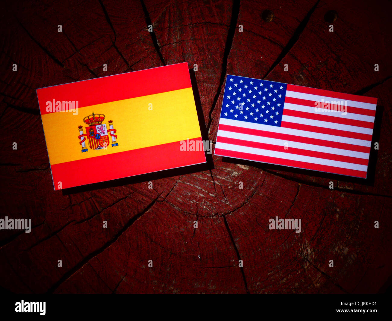 Spanish flag with USA flag on a tree stump isolated Stock Photo - Alamy