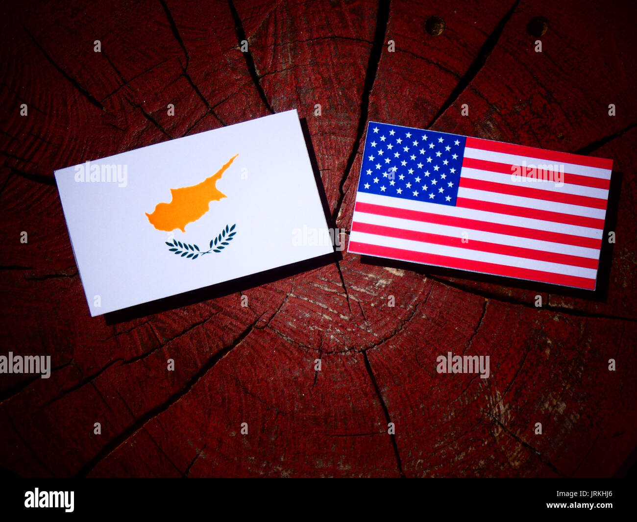 Cypriot flag with USA flag on a tree stump isolated Stock Photo - Alamy