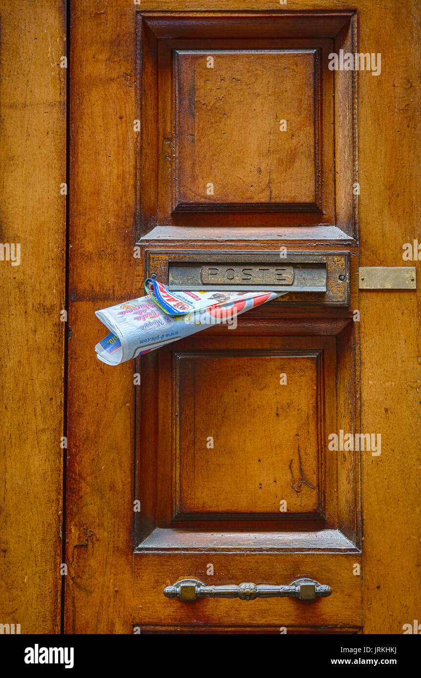 Advertising in a mailbox in a door Stock Photo - Alamy