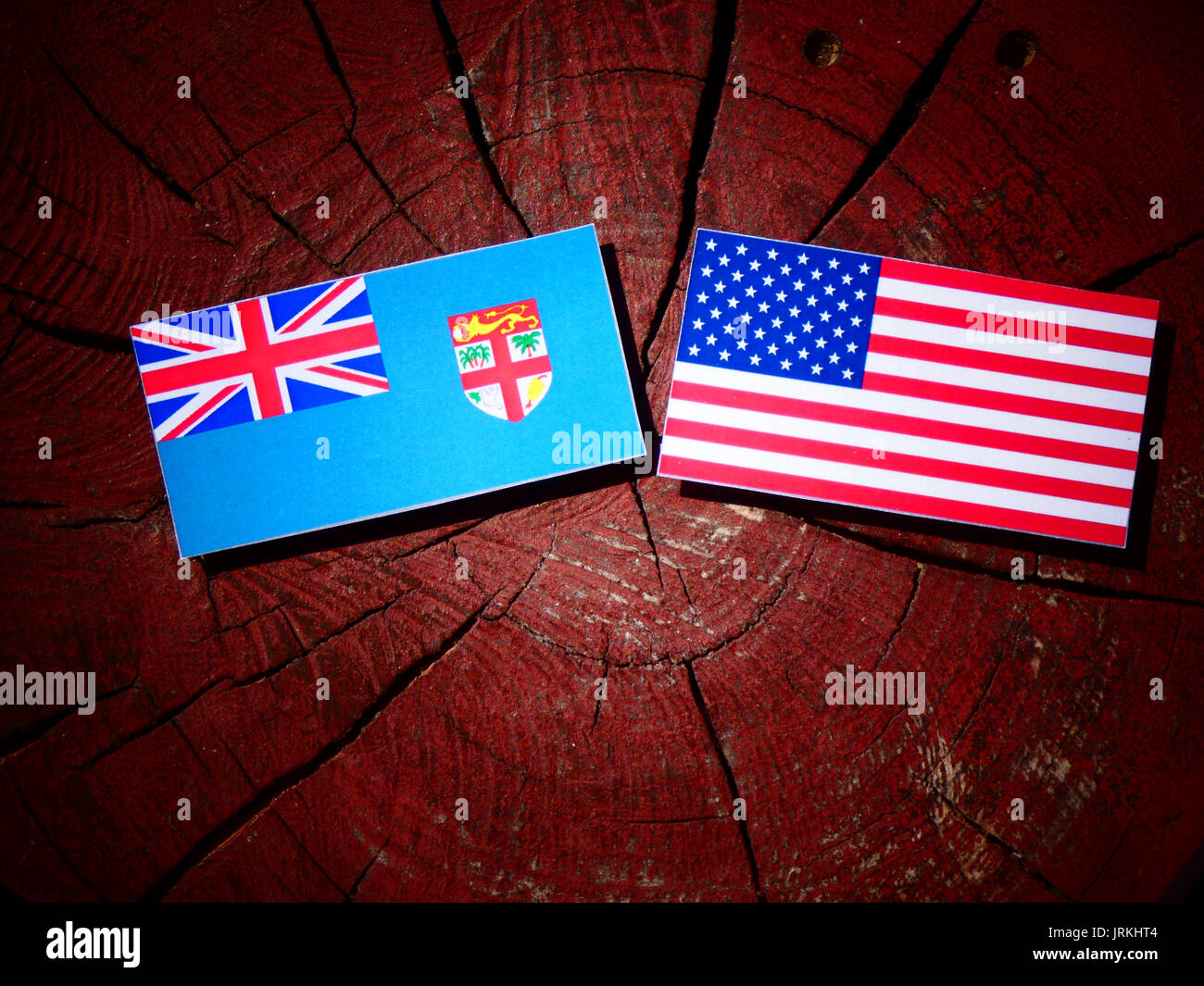 Fijian flag with USA flag on a tree stump isolated Stock Photo - Alamy