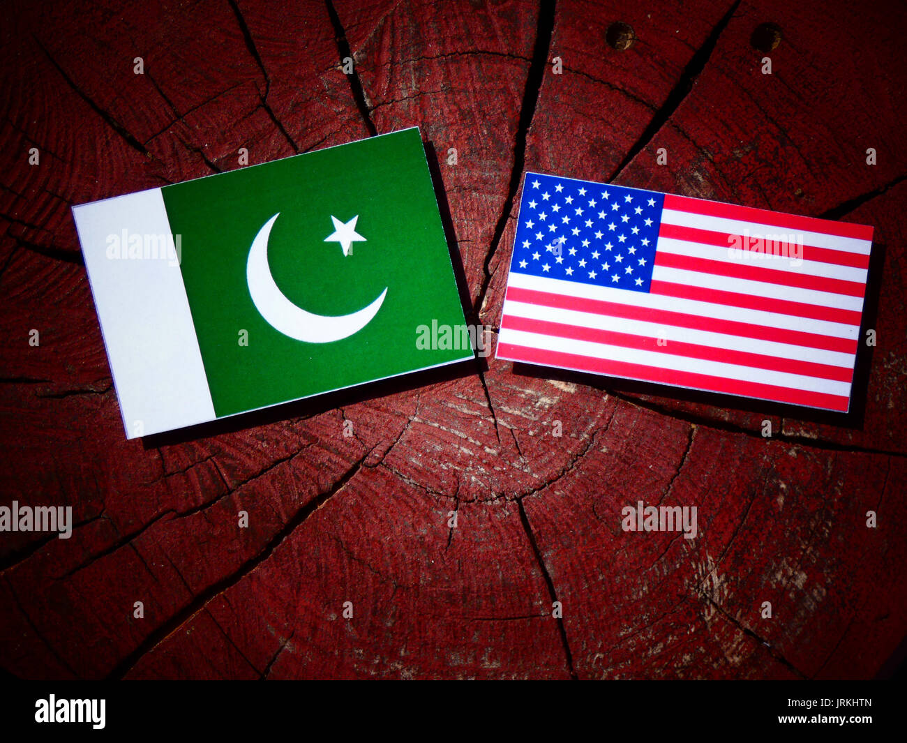 Pakistan flag with USA flag on a tree stump isolated Stock Photo - Alamy