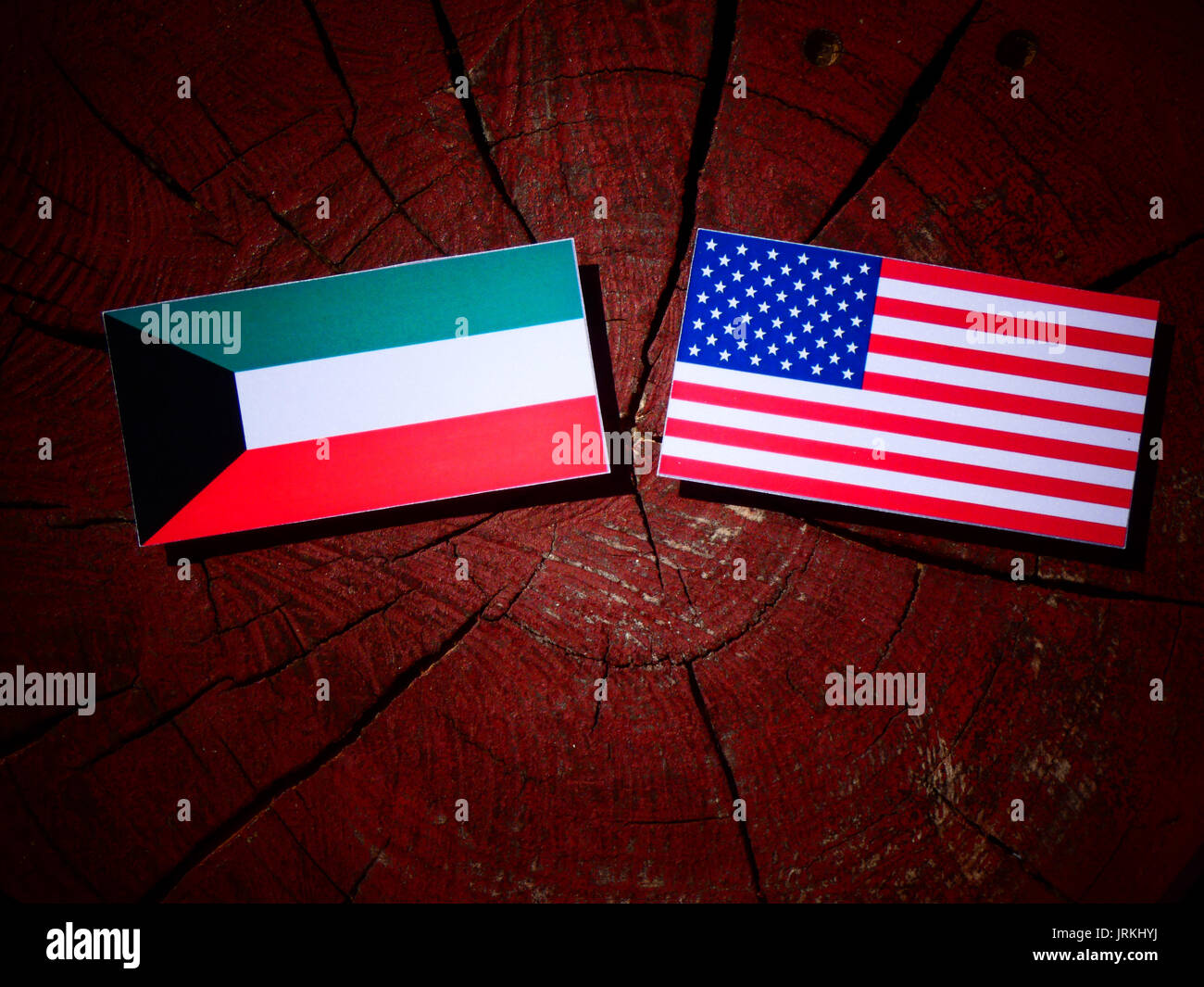 Kuwaiti flag with USA flag on a tree stump isolated Stock Photo - Alamy