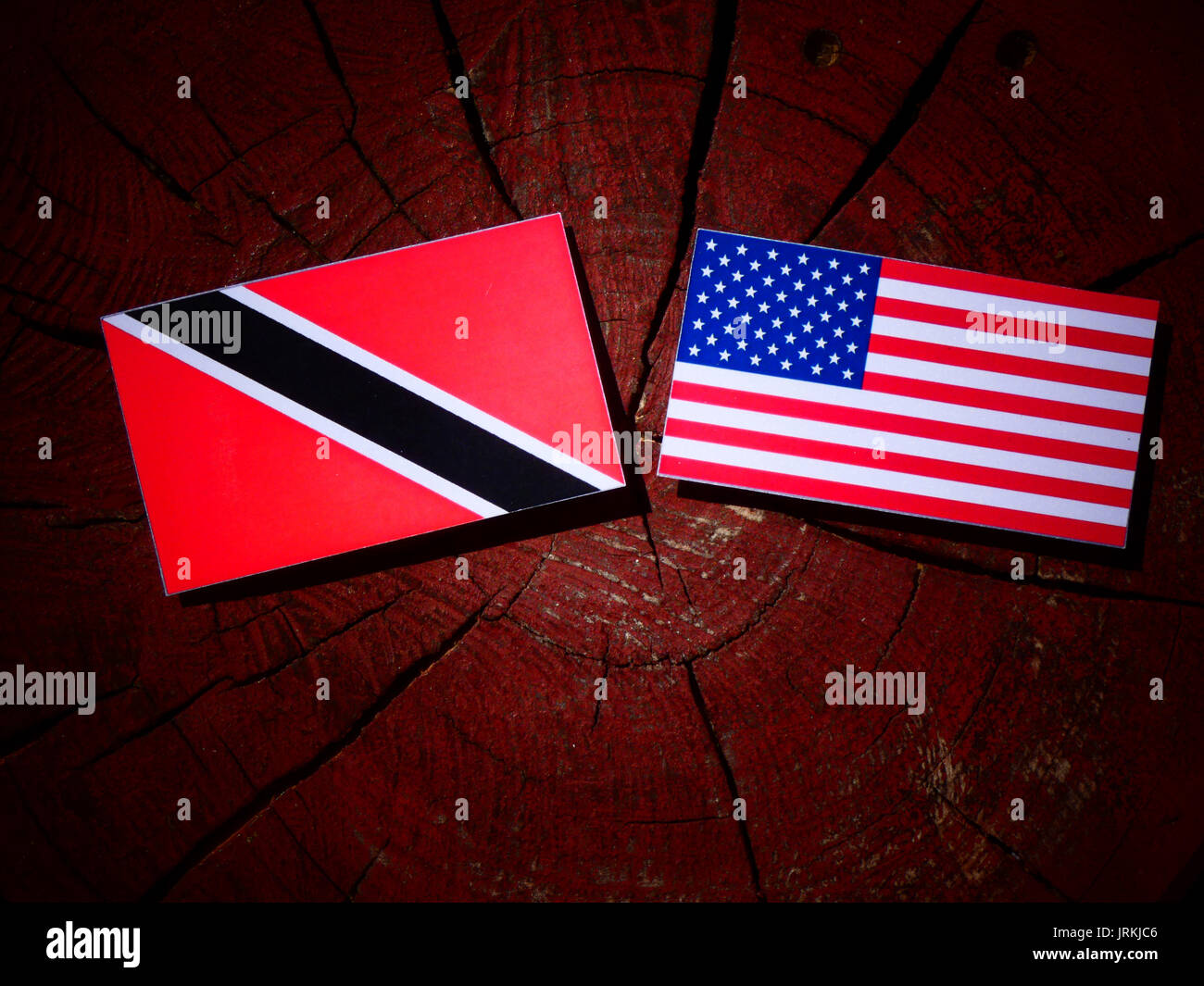 Trinidad and Tobago flag with USA flag on a tree stump isolated Stock ...