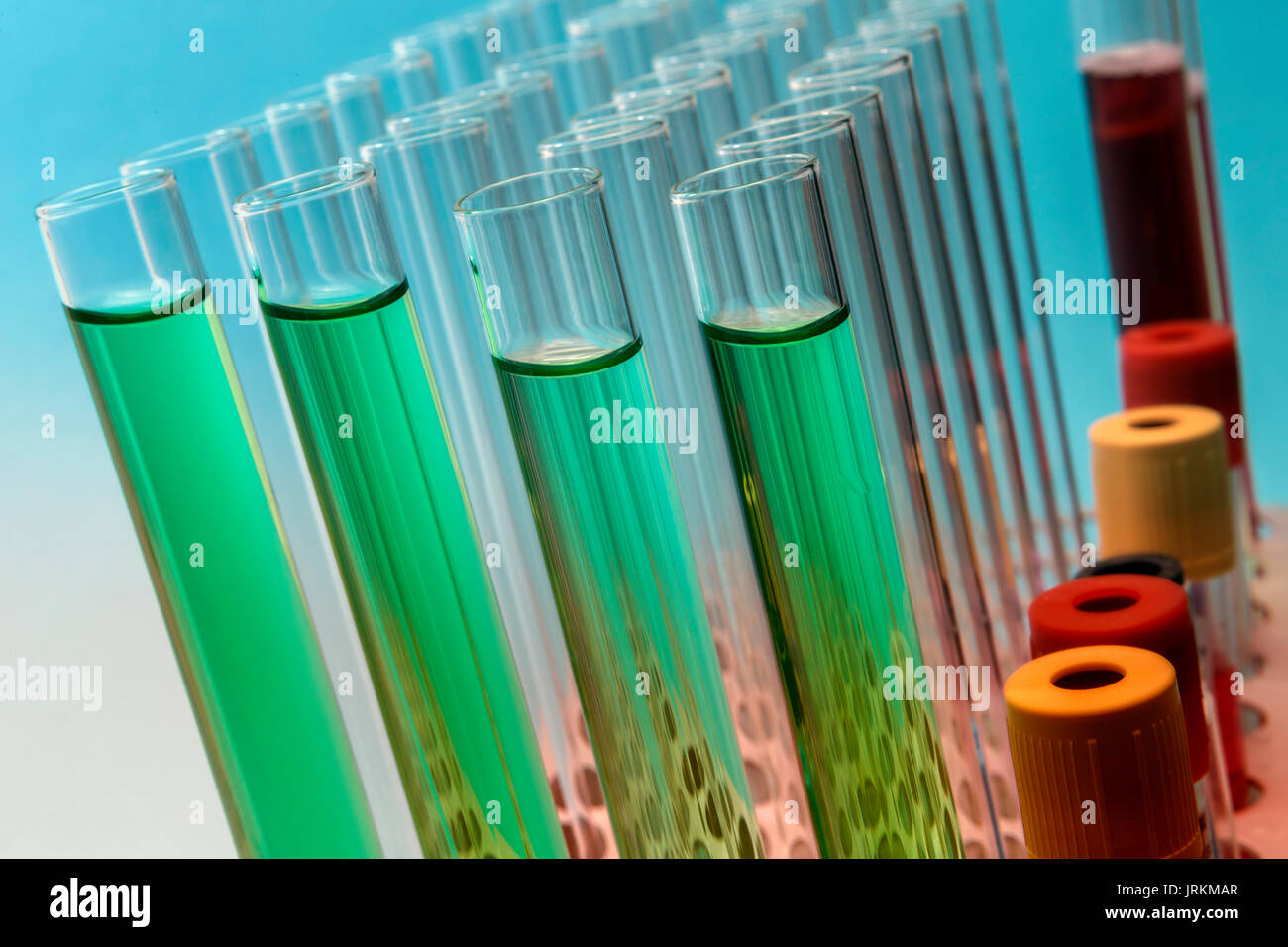 Row of test tubes in green tone Stock Photo - Alamy