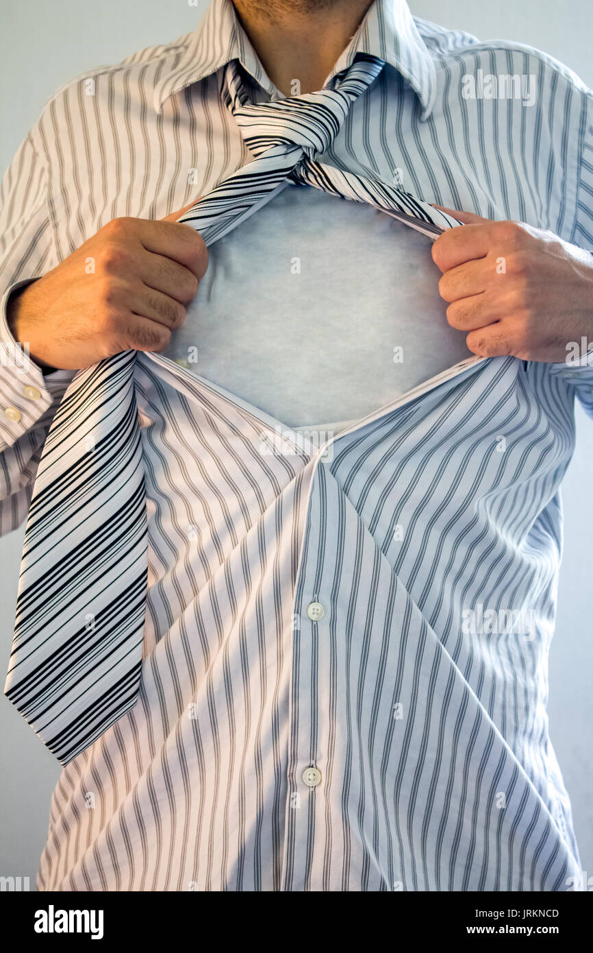 Businessman acting like a super hero, tearing his shirt off with white ...