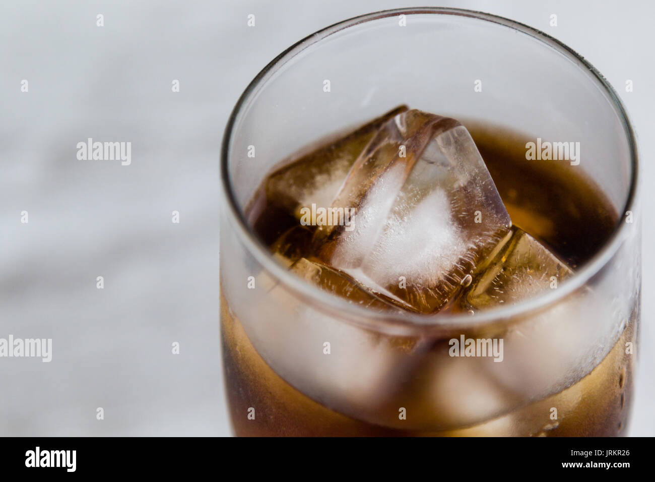 cola, soda in glass with big ice cubes Stock Photo - Alamy