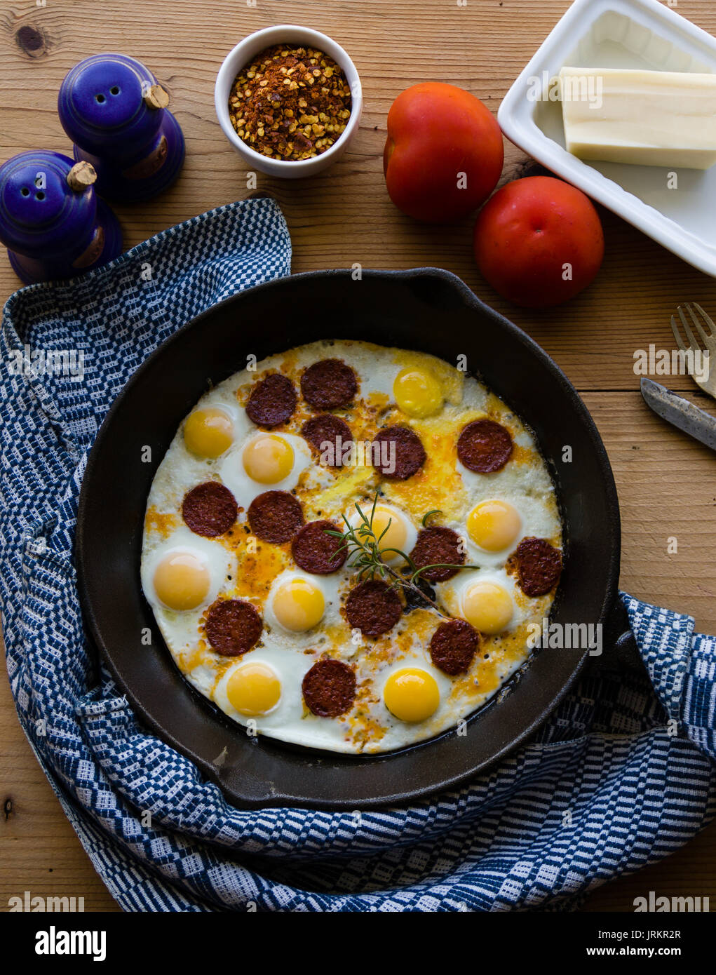 fried quail eggs with sausage in black pan Stock Photo - Alamy