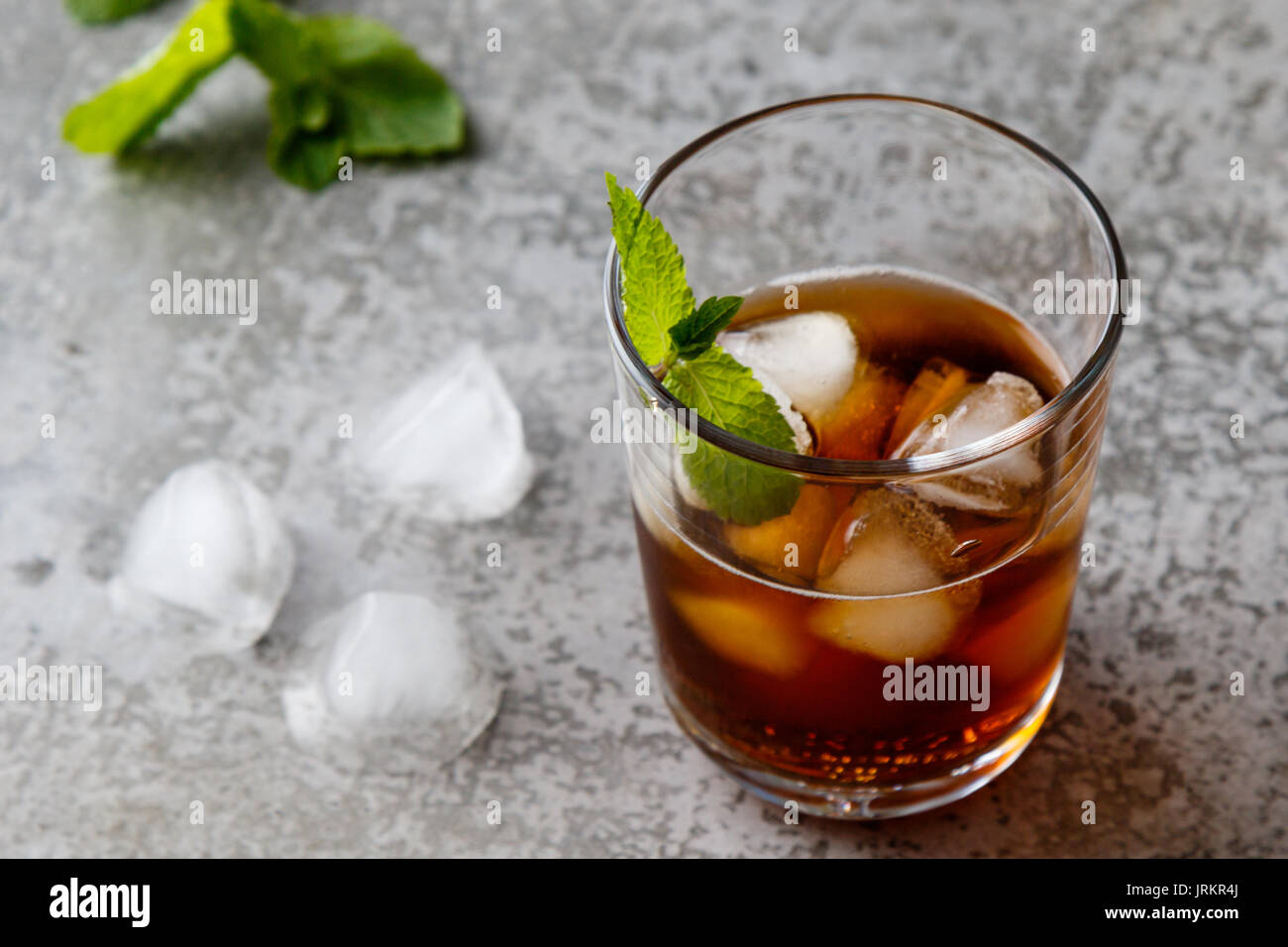 cold refreshing ice tea with ice cubes in glass Stock Photo - Alamy