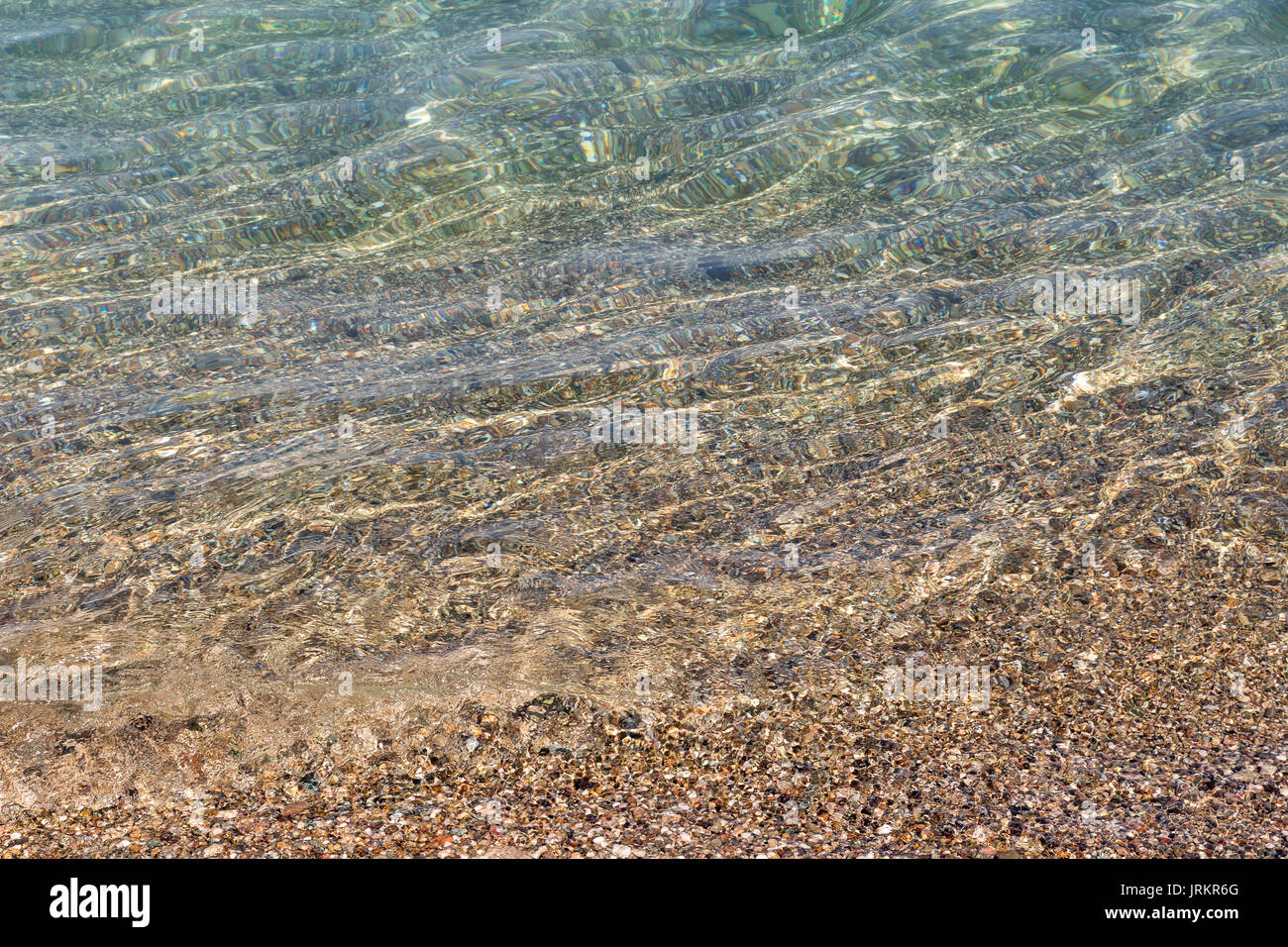 Sand the rocks and a blue Mediterranean sea Stock Photo - Alamy