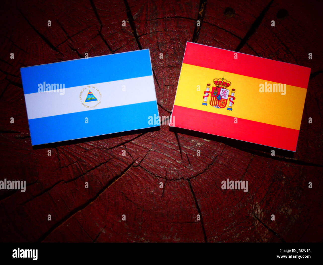 Nicaraguan flag with Spanish flag on a tree stump isolated Stock Photo ...
