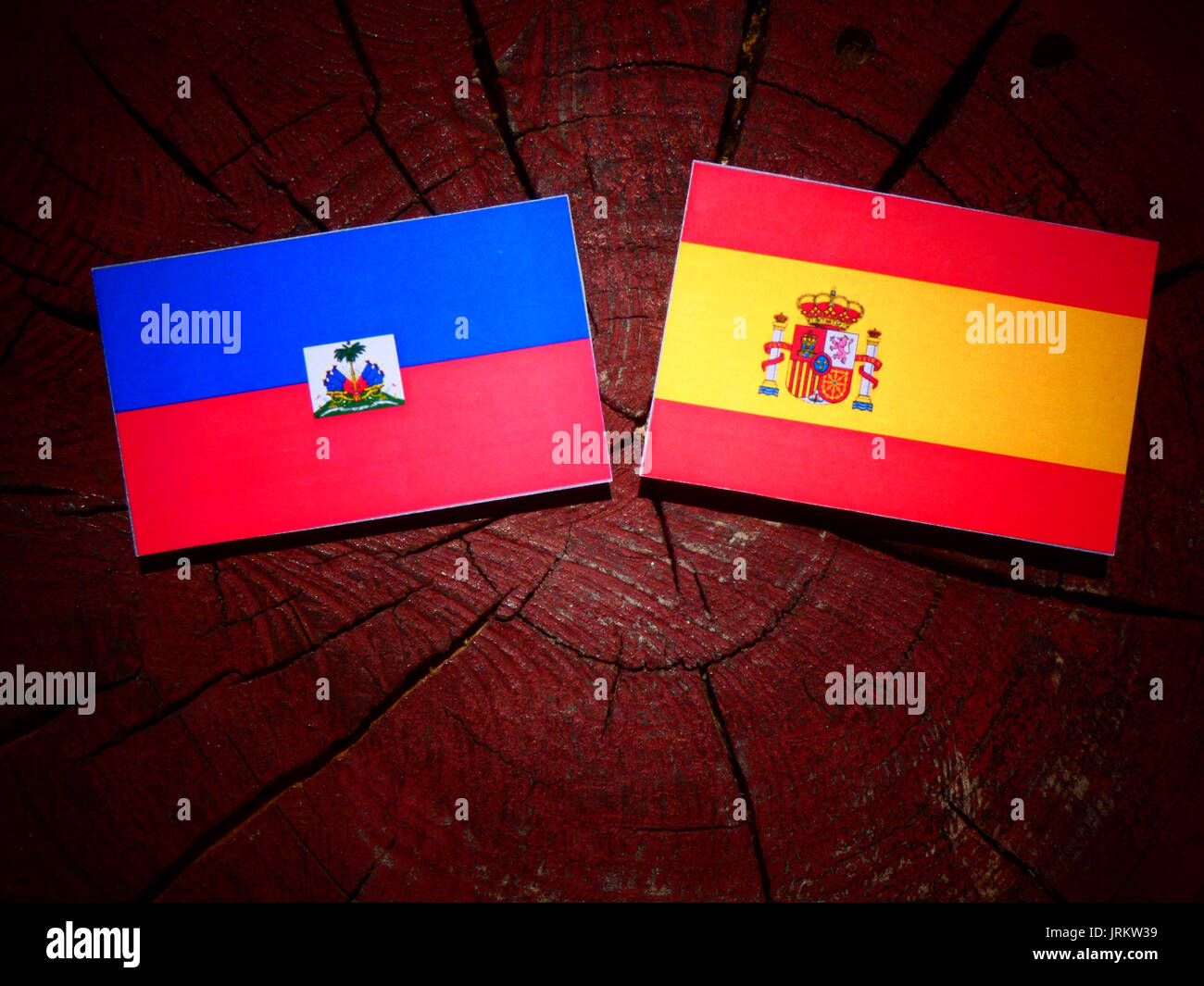 Haitian flag with Spanish flag on a tree stump isolated Stock Photo - Alamy