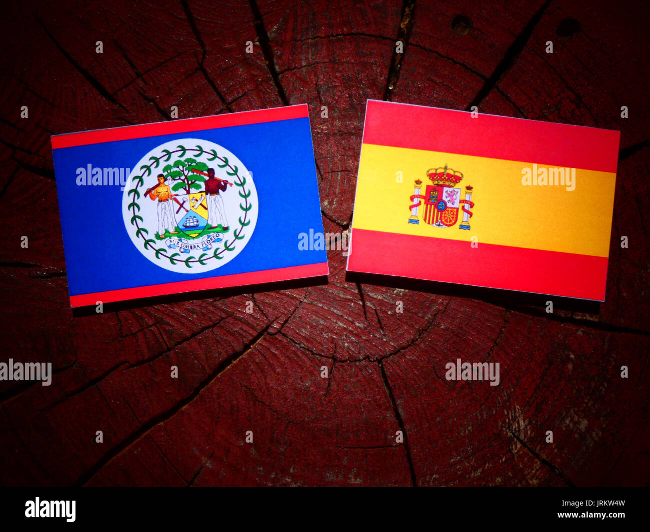 Belize flag with Spanish flag on a tree stump isolated Stock Photo - Alamy